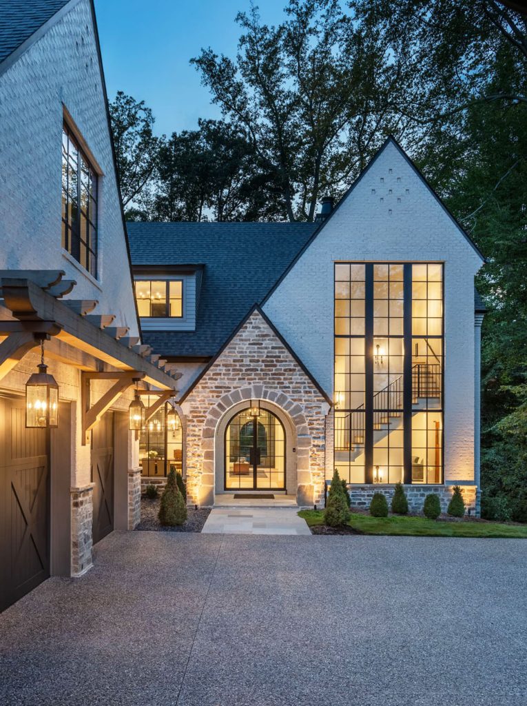 Modern Tudor Style Home Blends into Forested Surroundings