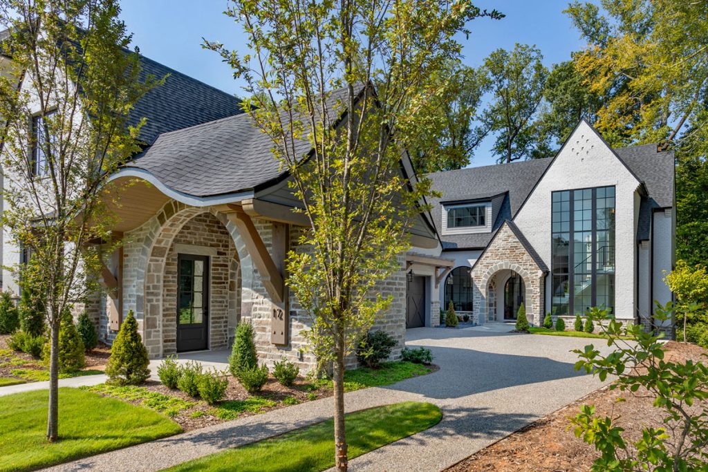 Modern Tudor Style Home Blends into Forested Surroundings