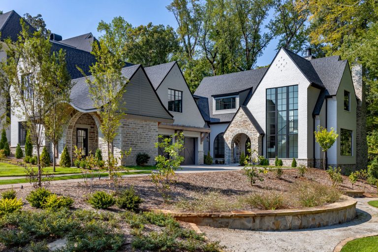 Modern Tudor Style Home Blends into Forested Surroundings