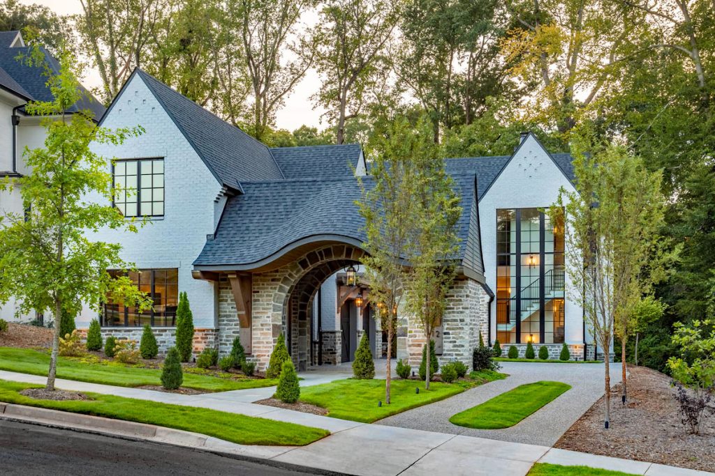 Modern Tudor Style Home Blends into Forested Surroundings