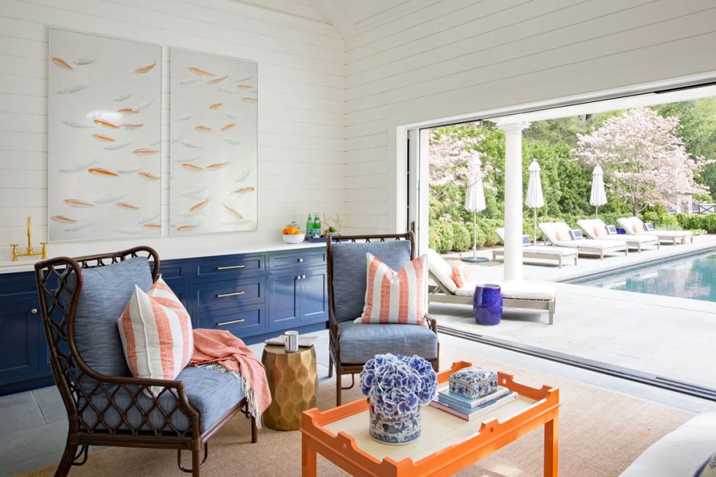 Shingle-Clad Pool House at the Edge of a Lush Backyard Oasis