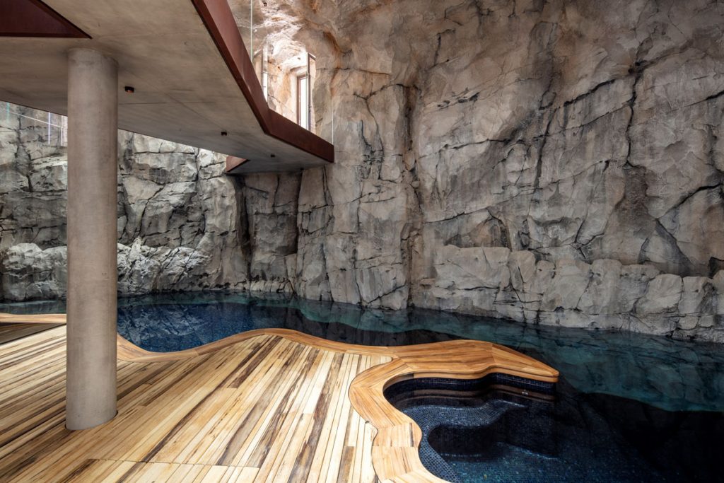 Modern Cave Villa Built into a Massive Rock with Underground Grotto
