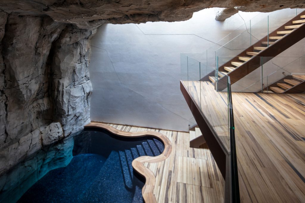 Modern Cave Villa Built into a Massive Rock with Underground Grotto