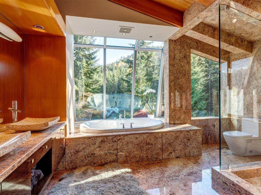 Iconic Waterfall House Built Into a Stone Cliff in Whistler